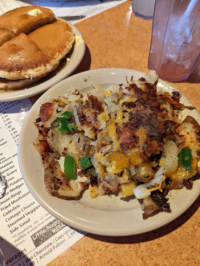 Crispy, cheese-laden hash browns that make you question why anyone would ever eat potatoes any other way, paired with fluffy pancakes for the ultimate breakfast duet.