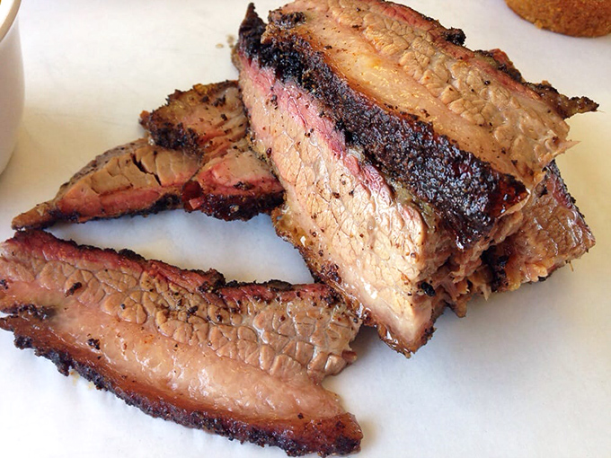 Brisket with that coveted pink smoke ring that BBQ aficionados dream about. Each slice tells the story of patience, smoke, and time-honored technique.