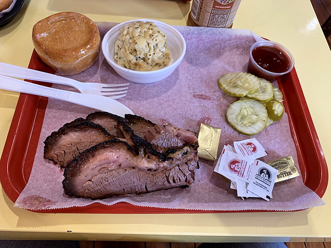 Brisket that would make a Texan weep with joy, complete with that coveted pink smoke ring. The pickles aren't just garnish&mdash;they're the perfect acidic counterpoint. 