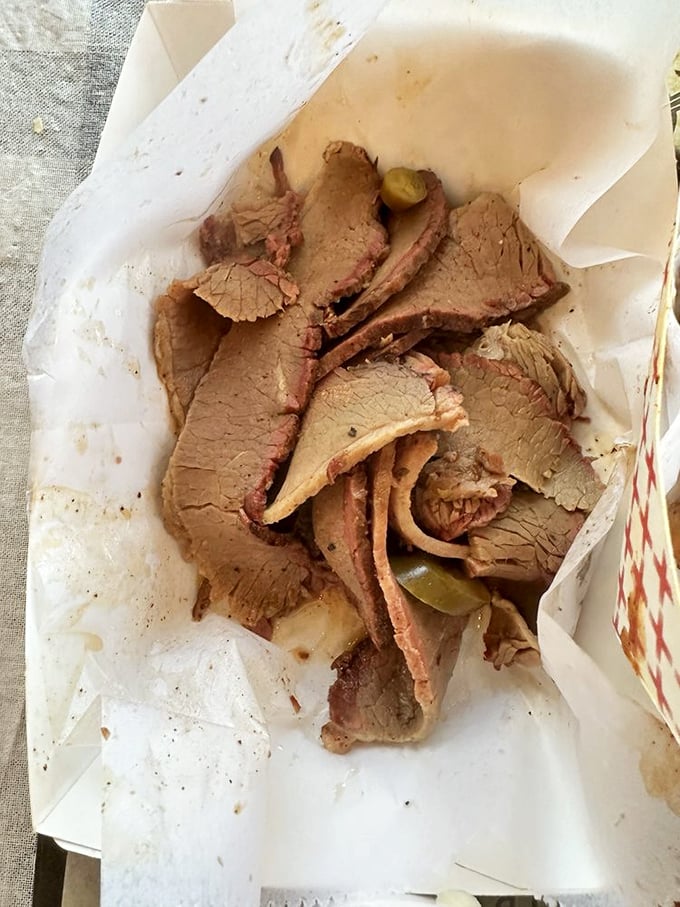 Brisket sliced thin enough to read through, yet substantial enough to change your day. The pink smoke ring is barbecue's diploma.