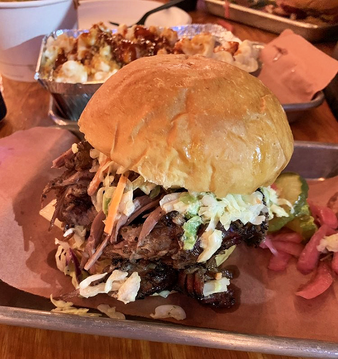 This isn't just a sandwich; it's architecture. Layers of smoky brisket, tangy slaw, and who knows what else – it's the Guggenheim of lunch.