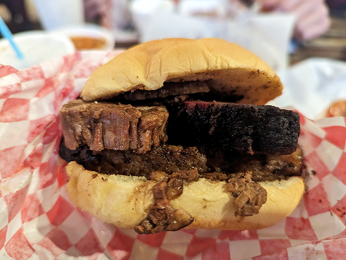 The brisket sandwich: where smoke meets art. That bark could make a Texas pitmaster weep with joy. 