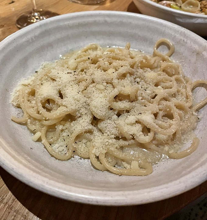 Bucatini cacio e pepe &ndash; where simplicity meets genius in a tangle of perfectly al dente pasta dusted with cheese.