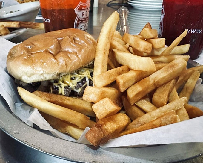 A burger and fries that would make any road trip worthwhile. Notice how the fries are practically jumping off the plate to meet you.