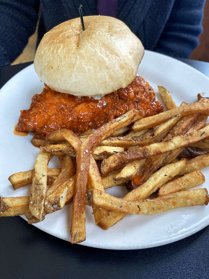 This isn't just a buffalo chicken sandwich&mdash;it's a flavor grenade with a bun for a pin. Those fries look like they've been to finishing school.