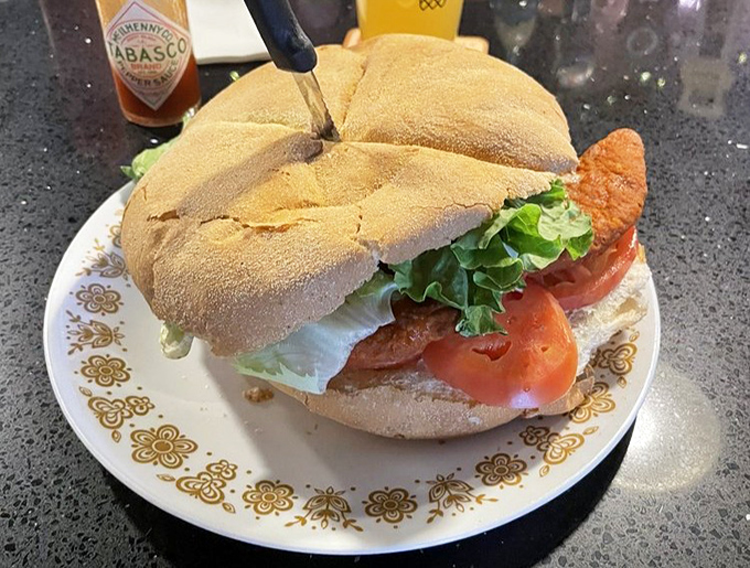 The Buffalo Chicken Sandwich arrives like a colorful postcard from flavor country. Fresh lettuce and tomato provide the perfect counterpoint to that spicy chicken.