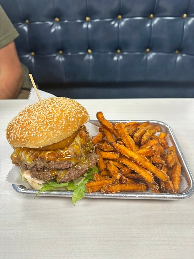 This isn't just a burger&mdash;it's architecture with cheese. The sesame seed bun crowns a masterpiece of beef and melty goodness.