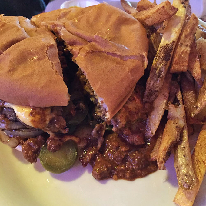 This isn't just a burger; it's an architectural masterpiece of beef, melted cheese, and pickles that requires a strategic approach and possibly a post-meal nap.