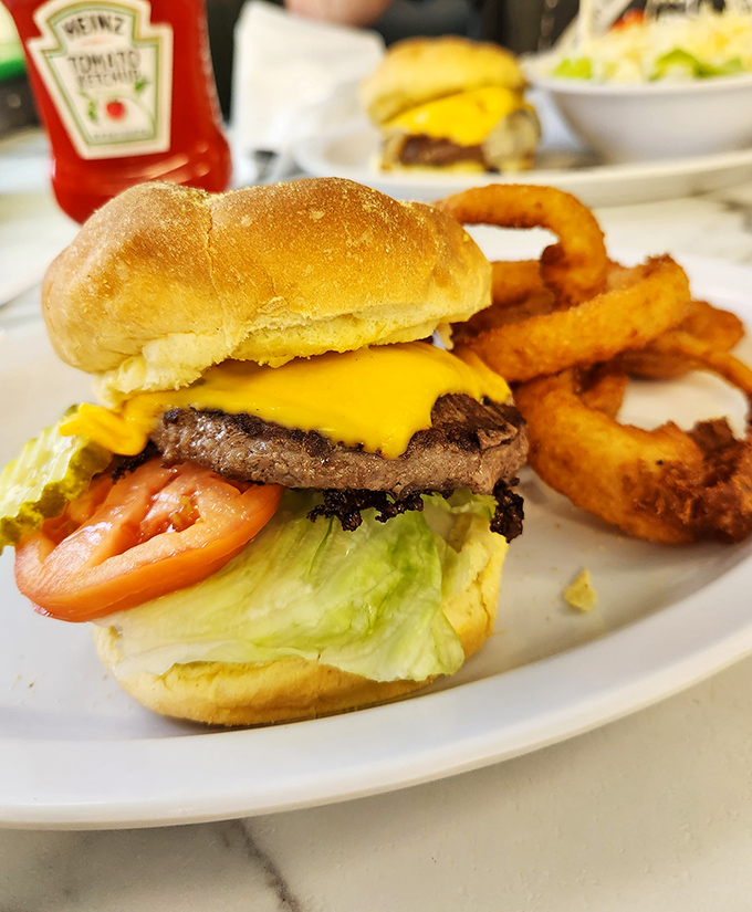 This isn't just a burger &ndash; it's edible architecture. Notice how that melted cheese drapes perfectly over the patty like a yellow security blanket.