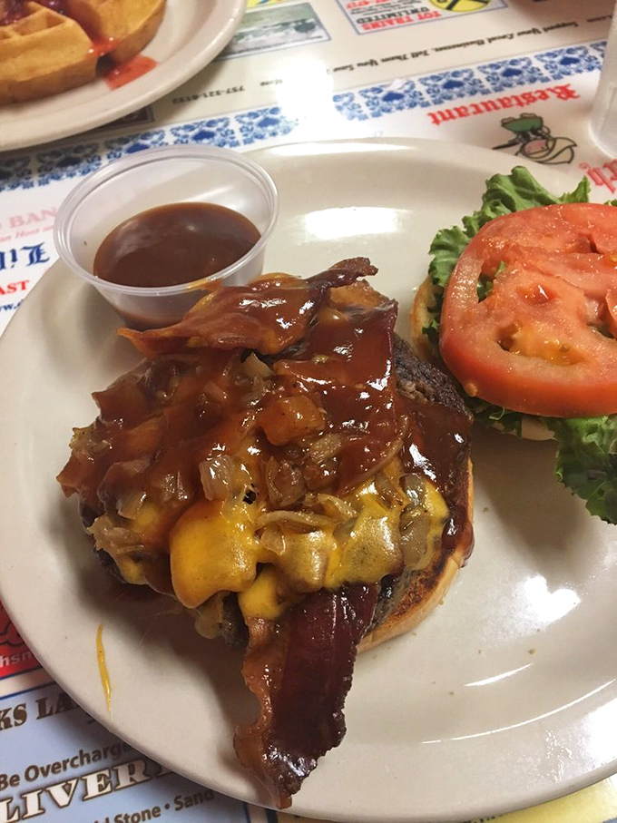 This isn't just a burger&mdash;it's a masterclass in excess. Melted cheese, bacon, and grilled onions creating a beautiful mess worth every napkin.