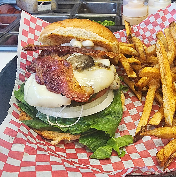 This isn't just a burger, it's architecture &ndash; layers of bacon, cheese, and fresh vegetables stacked with structural integrity that would impress Frank Lloyd Wright.
