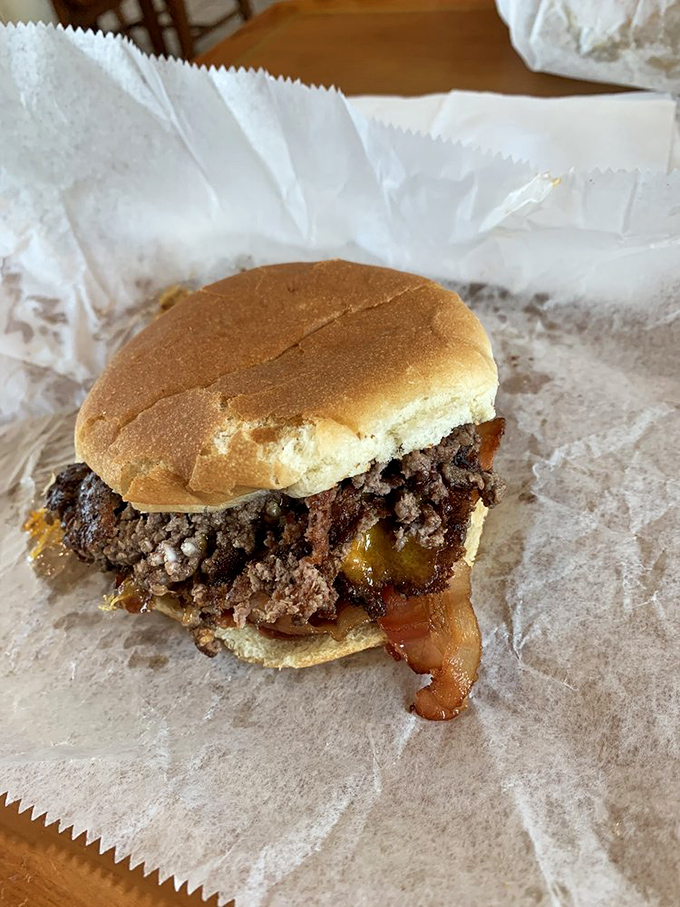 This isn't just a burger – it's edible architecture where beef, cheese, and bacon create a masterpiece that requires both hands and several napkins.