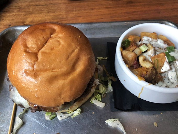 This isn't just a burger; it's a commitment to excellence. Paired with those herb-roasted potatoes, it's the kind of plate that makes you temporarily forget your table manners.