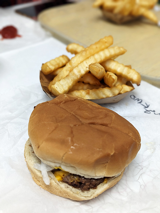 The crinkle-cut fries arrive golden and crispy, standing at attention next to a burger that doesn't need Instagram filters to look mouthwatering.