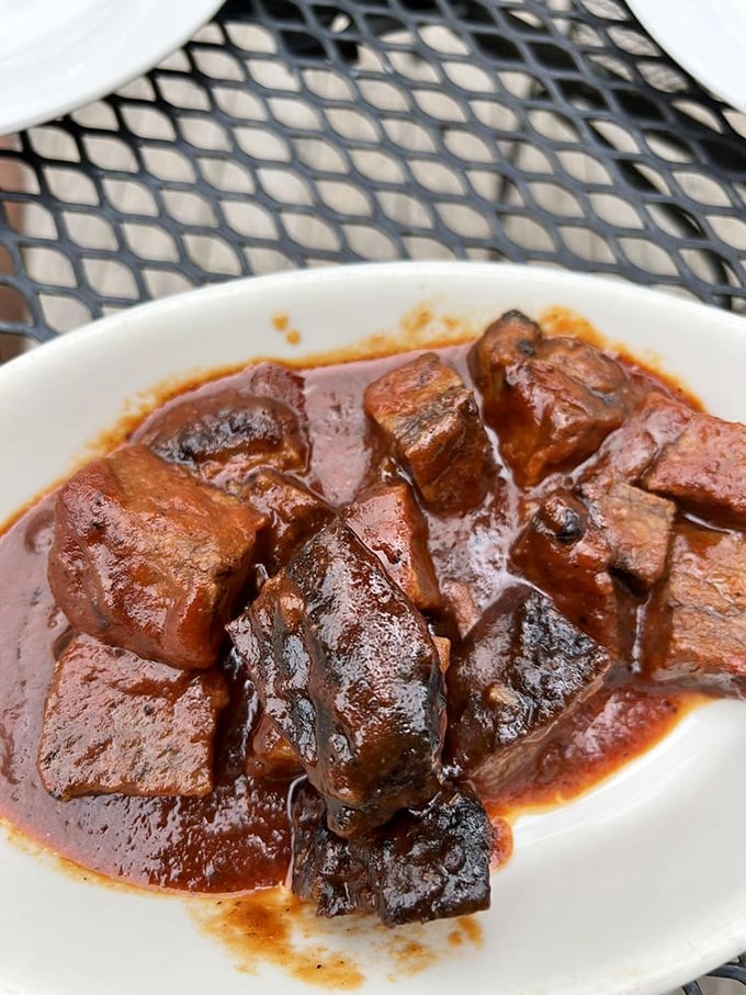 These burnt ends swimming in sauce are BBQ nirvana. Each cube of brisket is like a smoky, caramelized flavor bomb waiting to detonate.