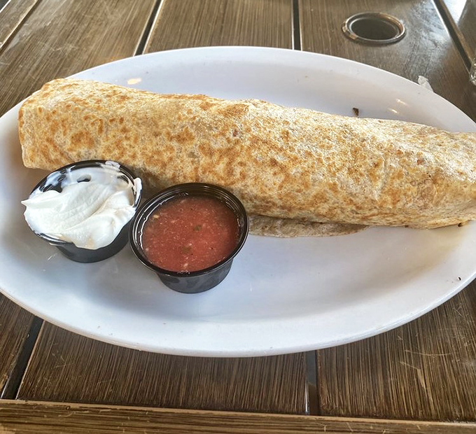 The Burrito Buster lives up to its name – a tortilla-wrapped treasure chest of breakfast goodness served with fresh salsa and sour cream.
