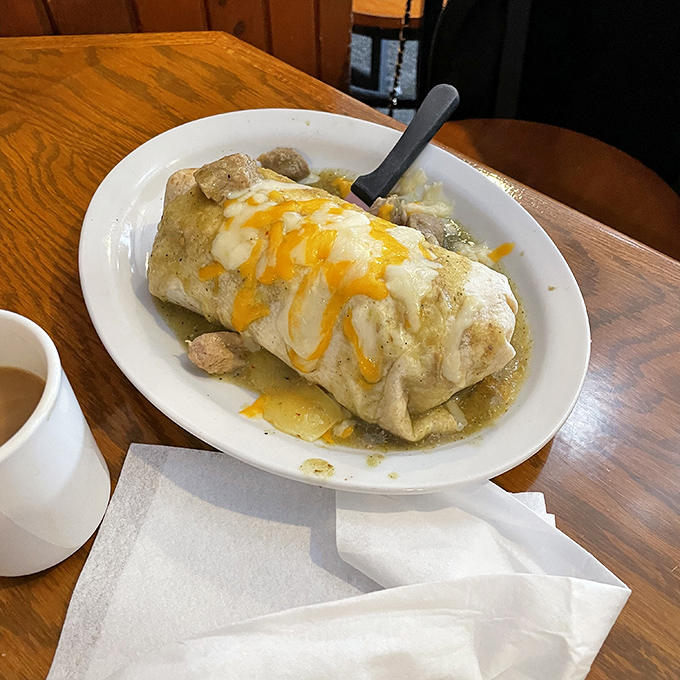 This breakfast burrito isn't just wrapped, it's smothered in a blanket of green chile sauce and melted cheese. The breakfast equivalent of a bear hug. 