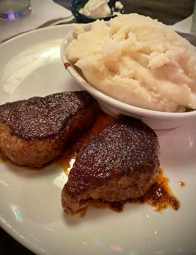 Two medallions of filet mignon with a side of cloud-like mashed potatoes. Proof that simplicity, when done right, is the ultimate sophistication.