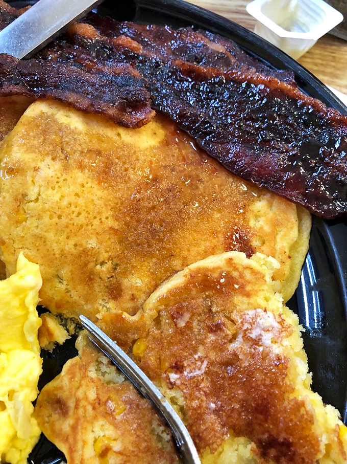 Golden, fluffy pancakes topped with fresh bananas and crispy bacon. Breakfast architecture at its finest&mdash;the Guggenheim of morning meals.