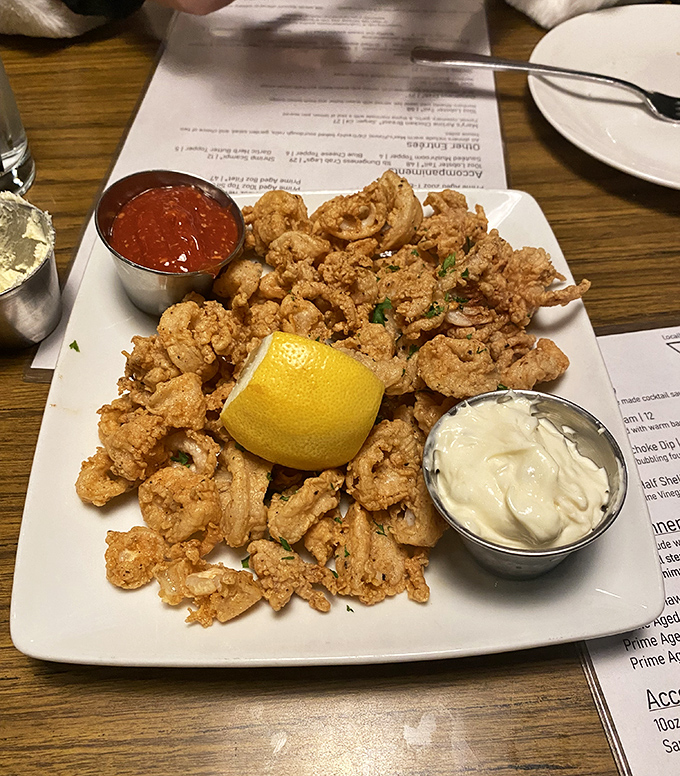 Crispy, golden calamari that shatters like glass between your teeth, served with two dipping sauces because life's too short for just one.