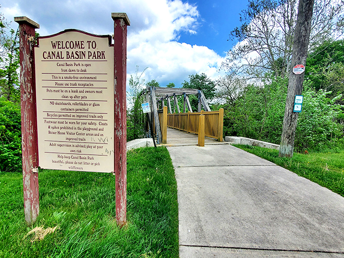 Canal Basin Park welcomes visitors with the kind of signage that says, "We have history, but we're not stuffy about it." Nature and heritage holding hands.