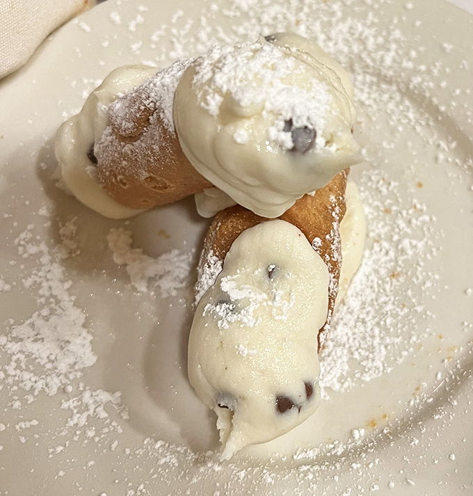 Crispy shells filled with sweet ricotta dreams, dusted with powdered sugar like edible snow angels.