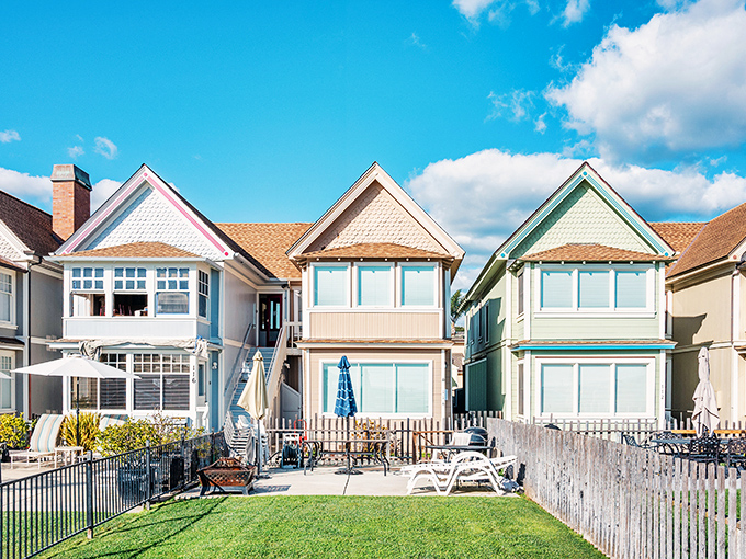 Beach houses in soft pastels line the shore, looking like they were designed by someone who couldn't decide between Mediterranean charm and coastal California cool.