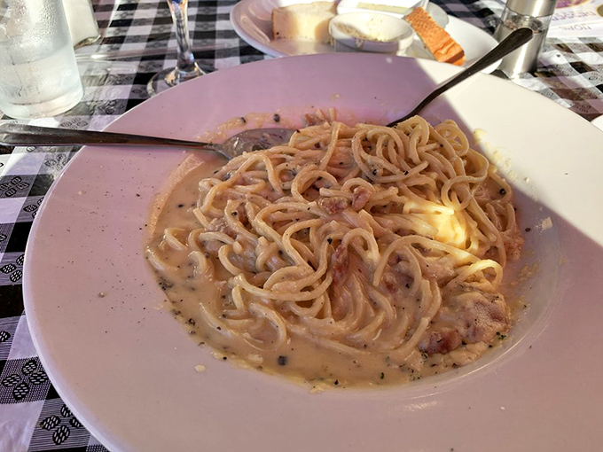 Carbonara that doesn't apologize for its richness—pasta swimming in a silky sauce that would make any Italian grandmother nod in silent approval.