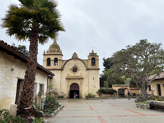 The Carmel Mission stands as a serene reminder of California's past, where history and spirituality blend beneath palm trees and blue skies.