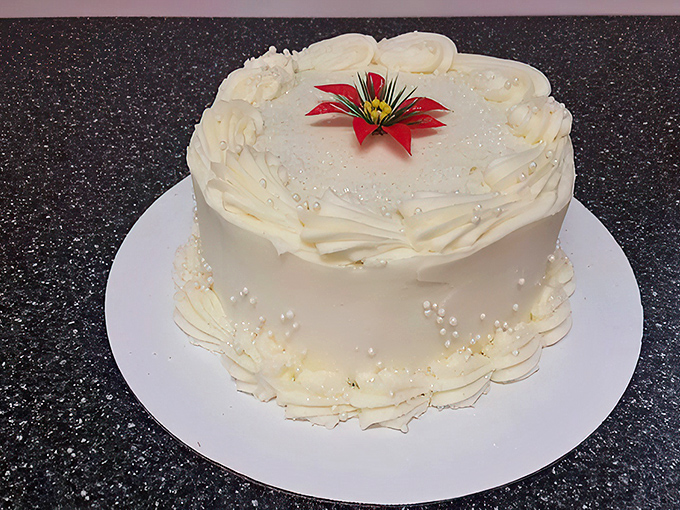 Wedding cake elegance meets small-town bakery authenticity. This pristine creation proves you don't need a big city ZIP code to find world-class pastry artistry.