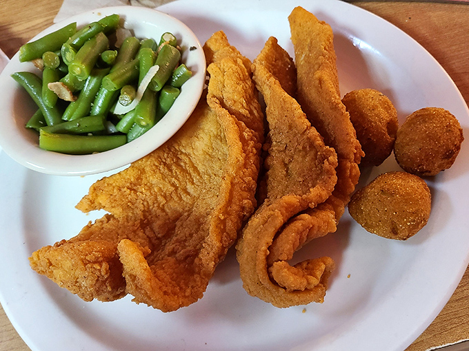 This catfish platter isn't just dinner—it's Florida on a plate, with hush puppies standing guard like delicious little sentinels.