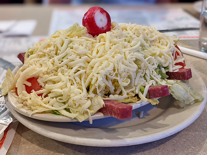 The Italian salad arrives like a snow-capped mountain of cheese, with radishes and pepperoncini playing hide-and-seek beneath&mdash;a prelude that could easily be the main event.