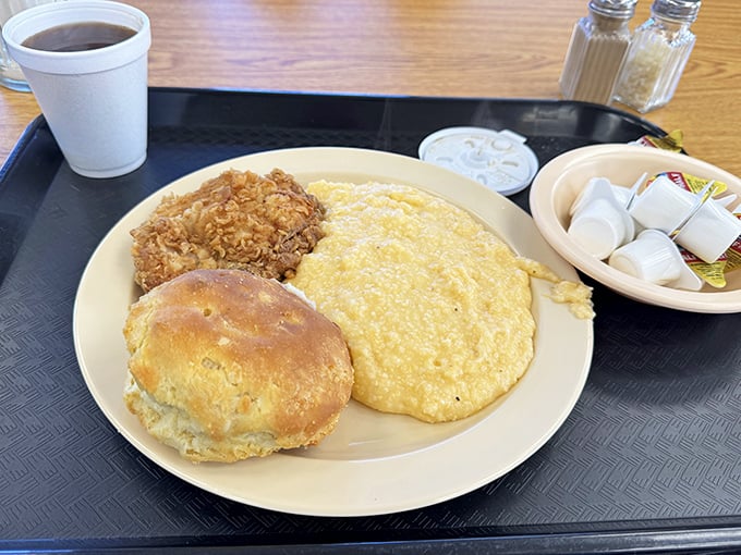 Breakfast of champions: golden grits, fluffy eggs, and a biscuit that would make your grandmother both proud and slightly jealous.