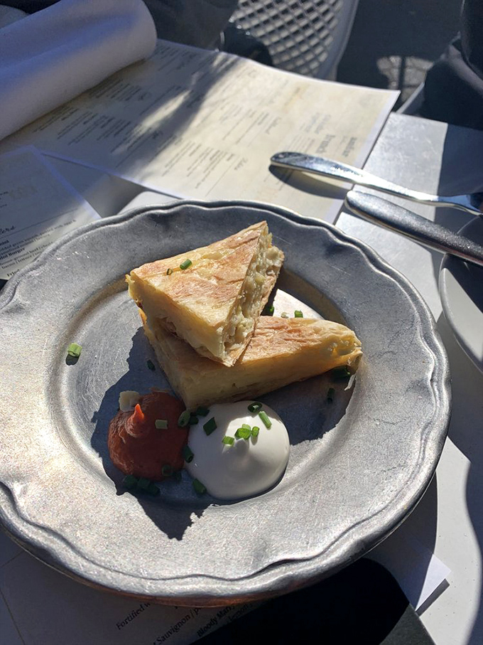 This cheese pie isn't just a snack&mdash;it's an education in Balkan comfort food. Flaky, cheesy, and paired with those two perfect dollops? Culinary poetry.