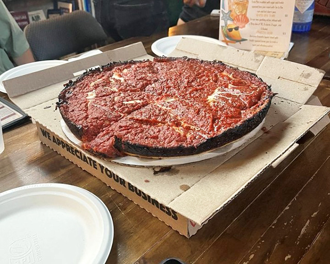 Behold the mothership: a full pan pizza with that signature charred cheese perimeter that makes Pequod's the stuff of Chicago legend.
