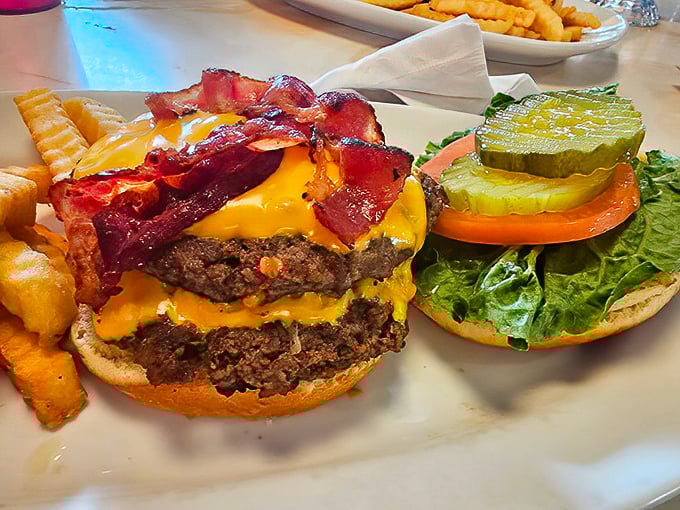 The bacon cheeseburger arrives like a skyscraper of satisfaction&mdash;structural engineering that prioritizes flavor over the laws of gravity.