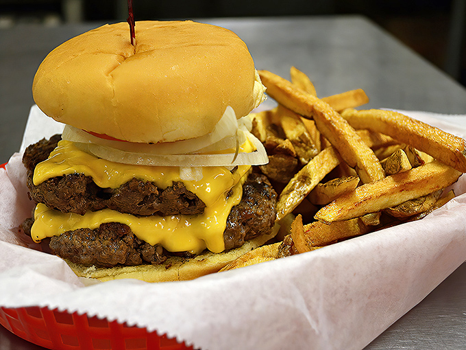 A burger that requires both hands and possibly a nap afterward. Those golden fries aren't just a side&mdash;they're co-stars in this delicious production.