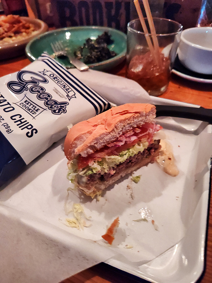 A burger that demands to be photographed before it's devoured &ndash; layered with fresh toppings and paired with classic kettle chips for that perfect crunch.