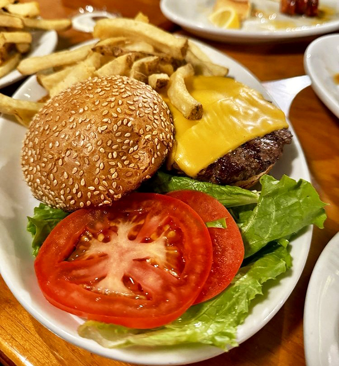 This isn't just a cheeseburger&mdash;it's architecture. The perfect stack of beef, cheese, lettuce and tomato on a sesame throne.