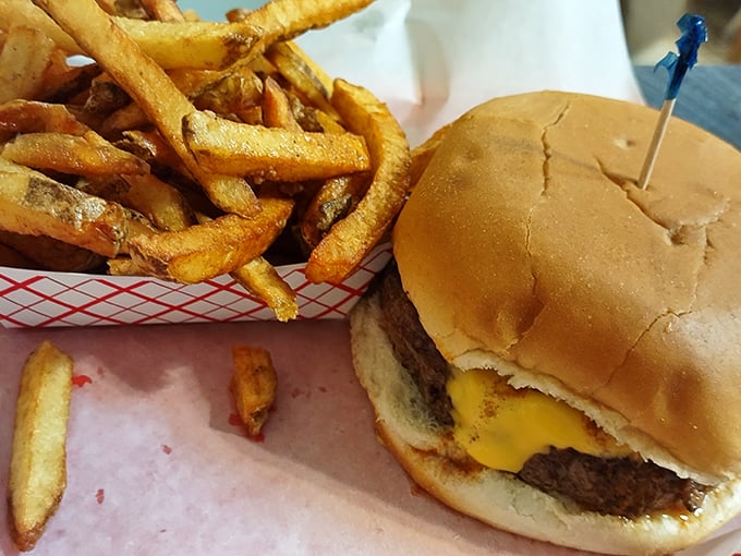 The cheeseburger and fries combo that makes you wonder why anyone bothers with white tablecloths when happiness comes on wax paper.