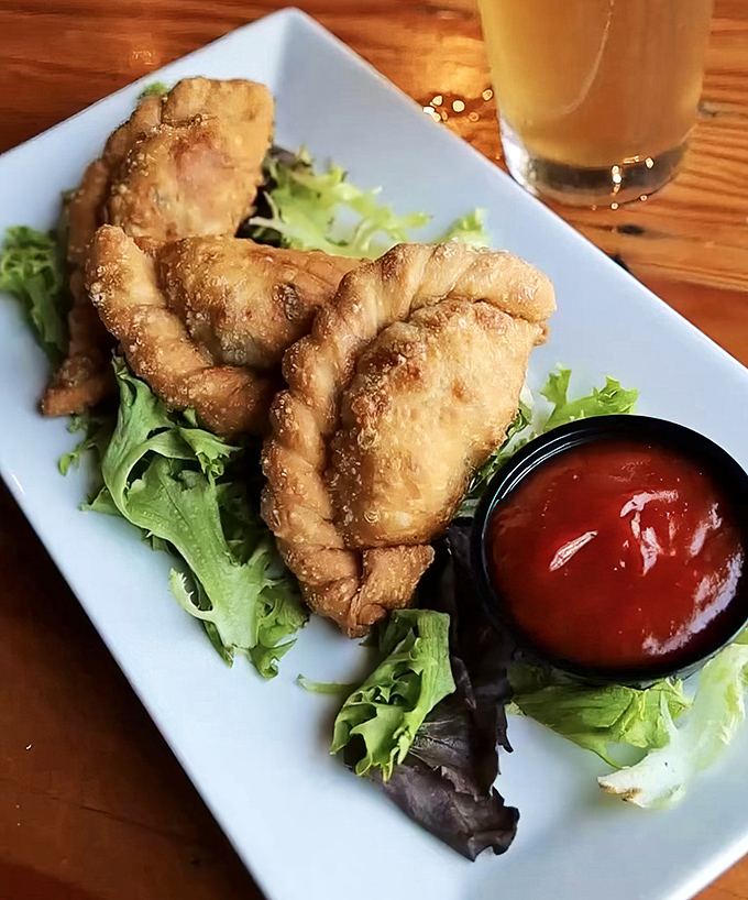 Golden-fried empanadas that shatter with each bite, served with house pickles that bring just enough tang to cut through the richness.