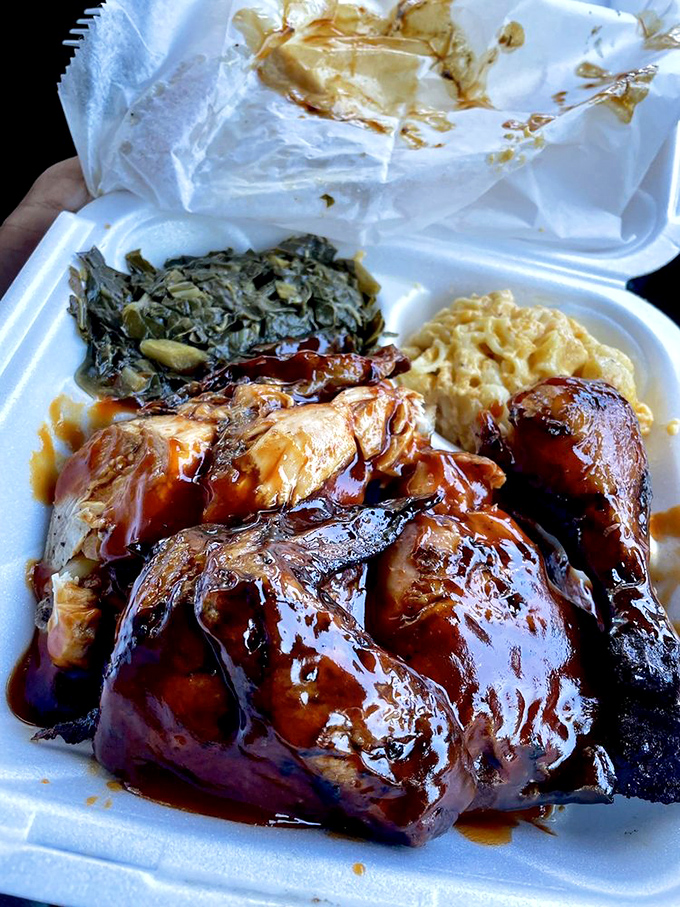 Smoky chicken nestled beside mac and cheese and collard greens &ndash; the holy trinity of Southern comfort on styrofoam.
