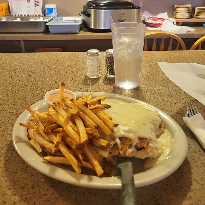 Comfort food perfection&mdash;golden fries alongside what appears to be chicken fried steak smothered in country gravy. Diet plans, consider yourselves postponed.