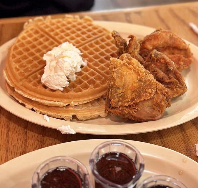 The ultimate power couple: crispy chicken and fluffy waffles with butter melting into every perfect square. Romance on a plate.