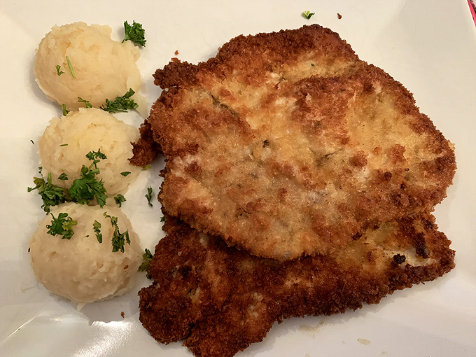 This golden-brown kotlet schabowy isn't just a chicken cutlet &ndash; it's a masterclass in crispy perfection with pillowy mashed potatoes standing guard. 