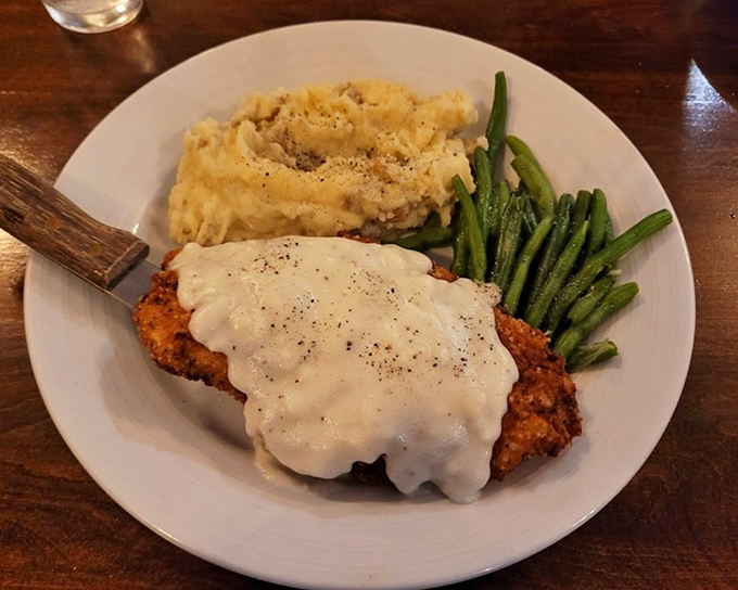 Chicken fried steak that's crispy where it should be, tender where it matters, and smothered in gravy that could make a vegetarian question their life choices.