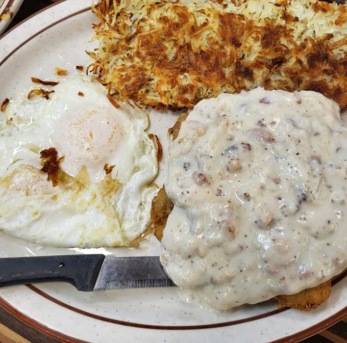 Crispy hash browns, sunny-side-up eggs, and country gravy that could make a vegetarian question their life choices. Comfort food that hugs you from the inside.