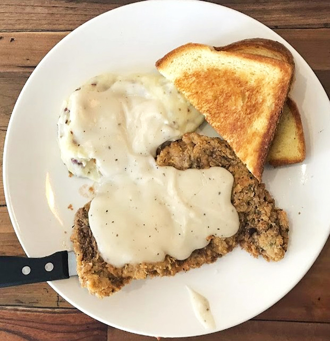 Country fried steak smothered in gravy – because sometimes breakfast needs to be hearty enough to fuel a cattle drive or just your Tuesday.