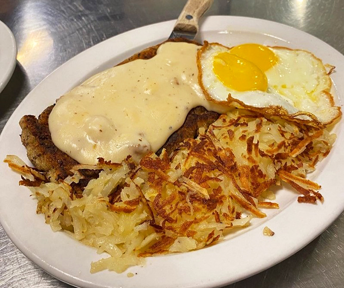 Chicken fried steak wearing a blanket of gravy like it's ready for a nap &ndash; and so will you be.