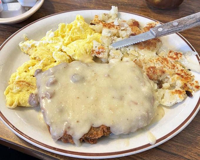Country-fried steak swimming in gravy &ndash; because sometimes your arteries deserve a vacation day.